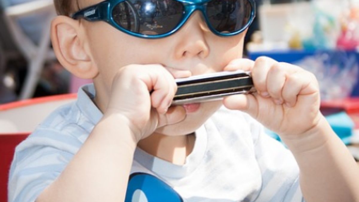 boy playing harmonica