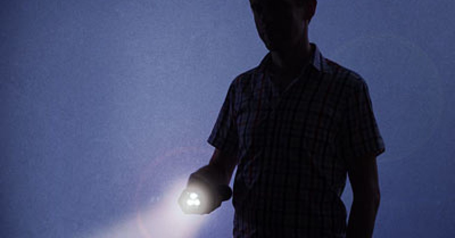 flashlight shining on someone